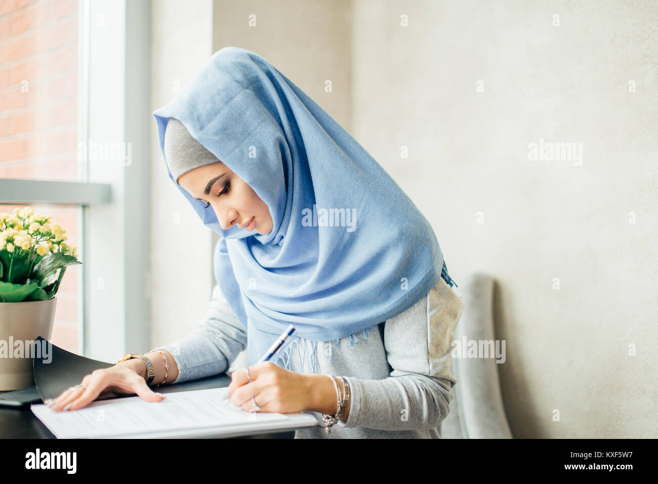 beautiful Muslim woman working with documents. business, lifestyle ...