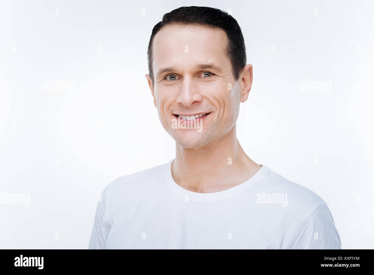 Positive handsome man smiling Stock Photo - Alamy Positive handsome man smiling Stock Photo - Alamy