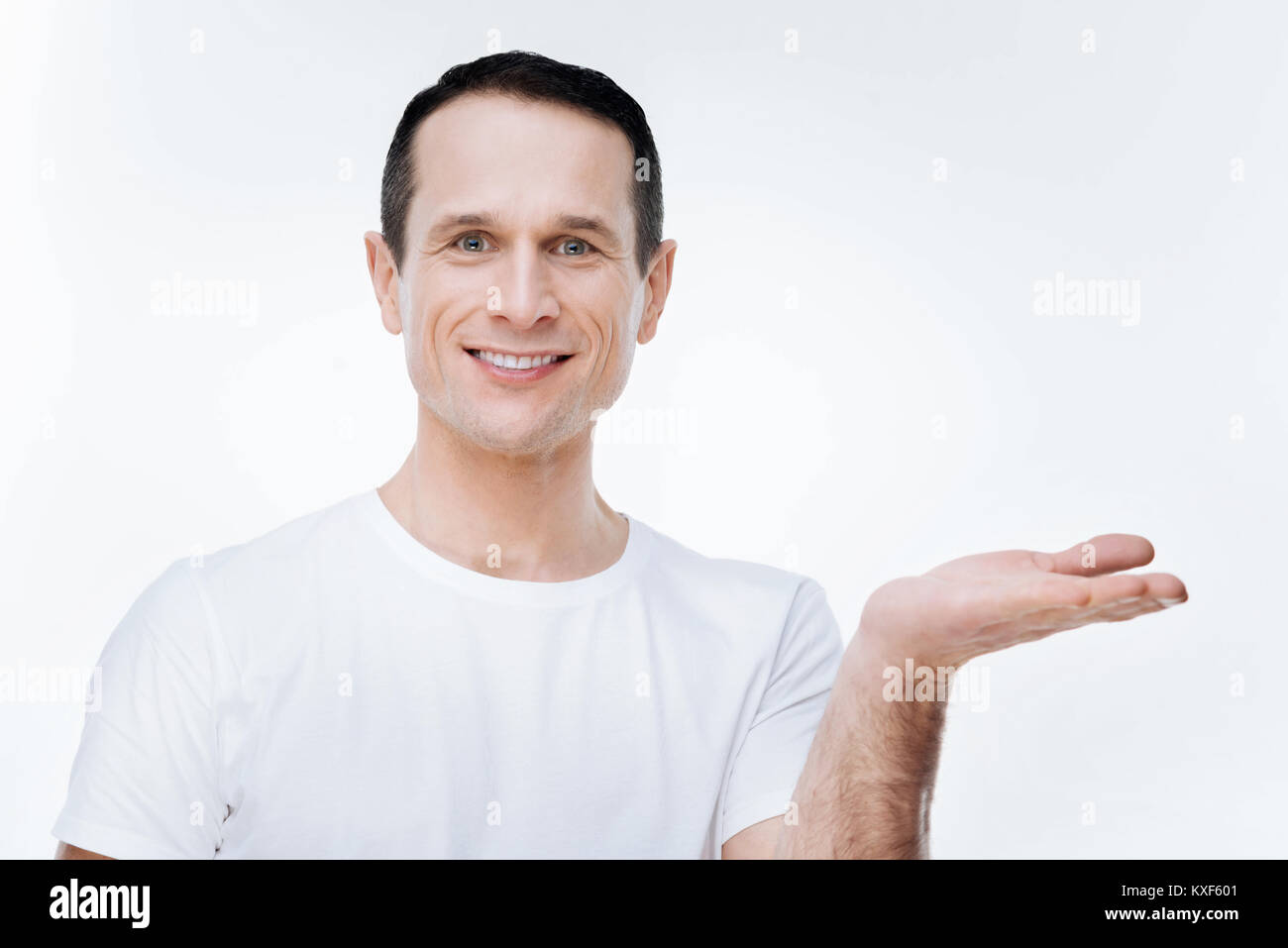 Cheerful delighted man smiling Stock Photo - Alamy