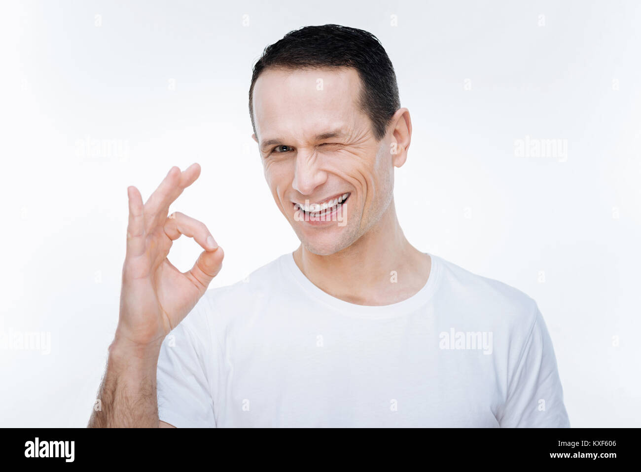 Delighted happy man winking Stock Photo - Alamy
