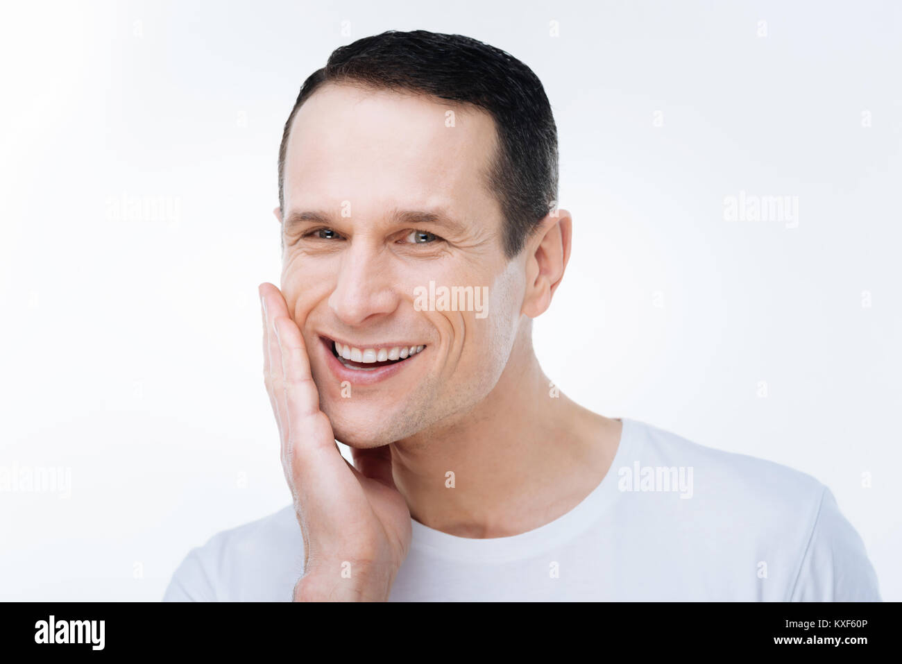 Positive joyful man touching his cheek Stock Photo - Alamy Positive joyful man touching his cheek Stock Photo - Alamy