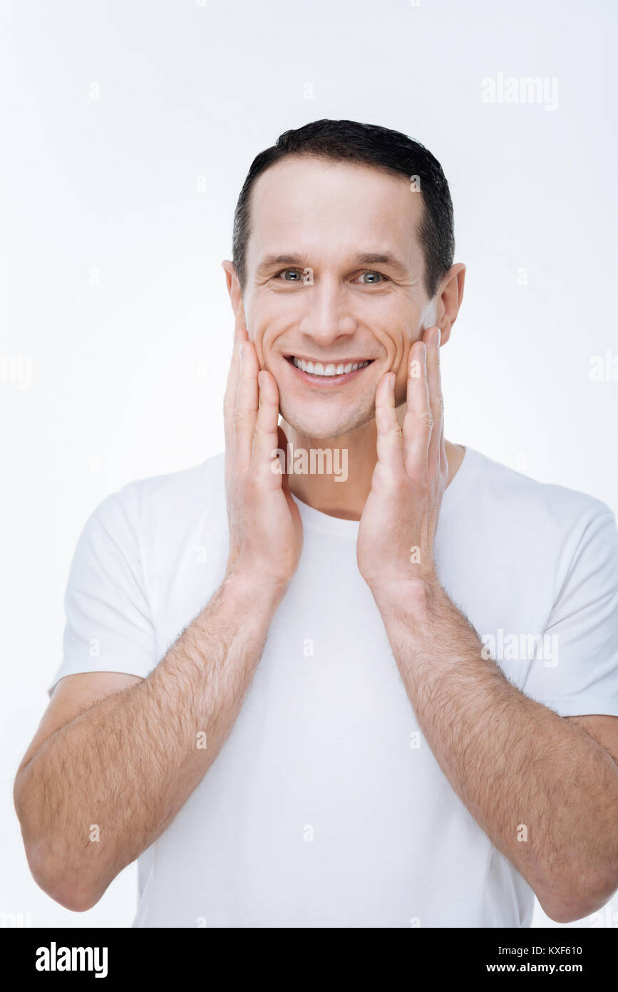 Positive happy man standing against white background Stock Photo - Alamy