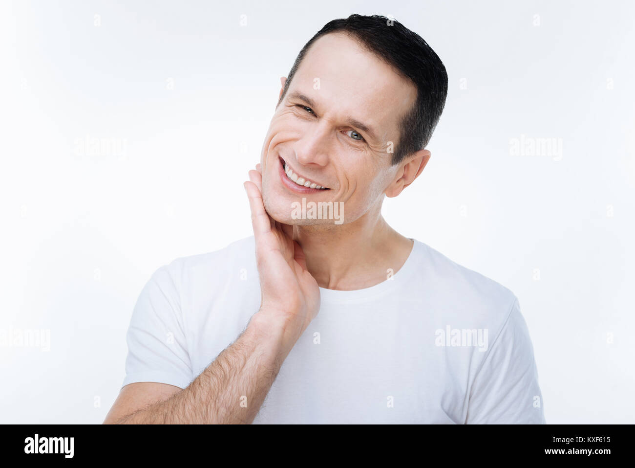 Happy delighted man turning his head Stock Photo - Alamy