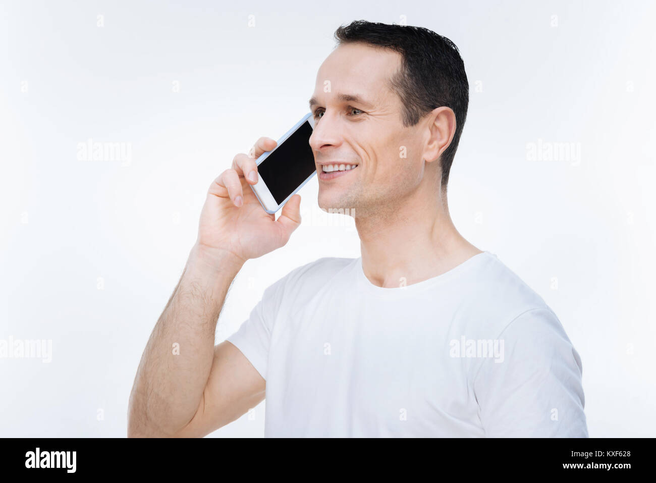 Delighted happy man making a call Stock Photo - Alamy