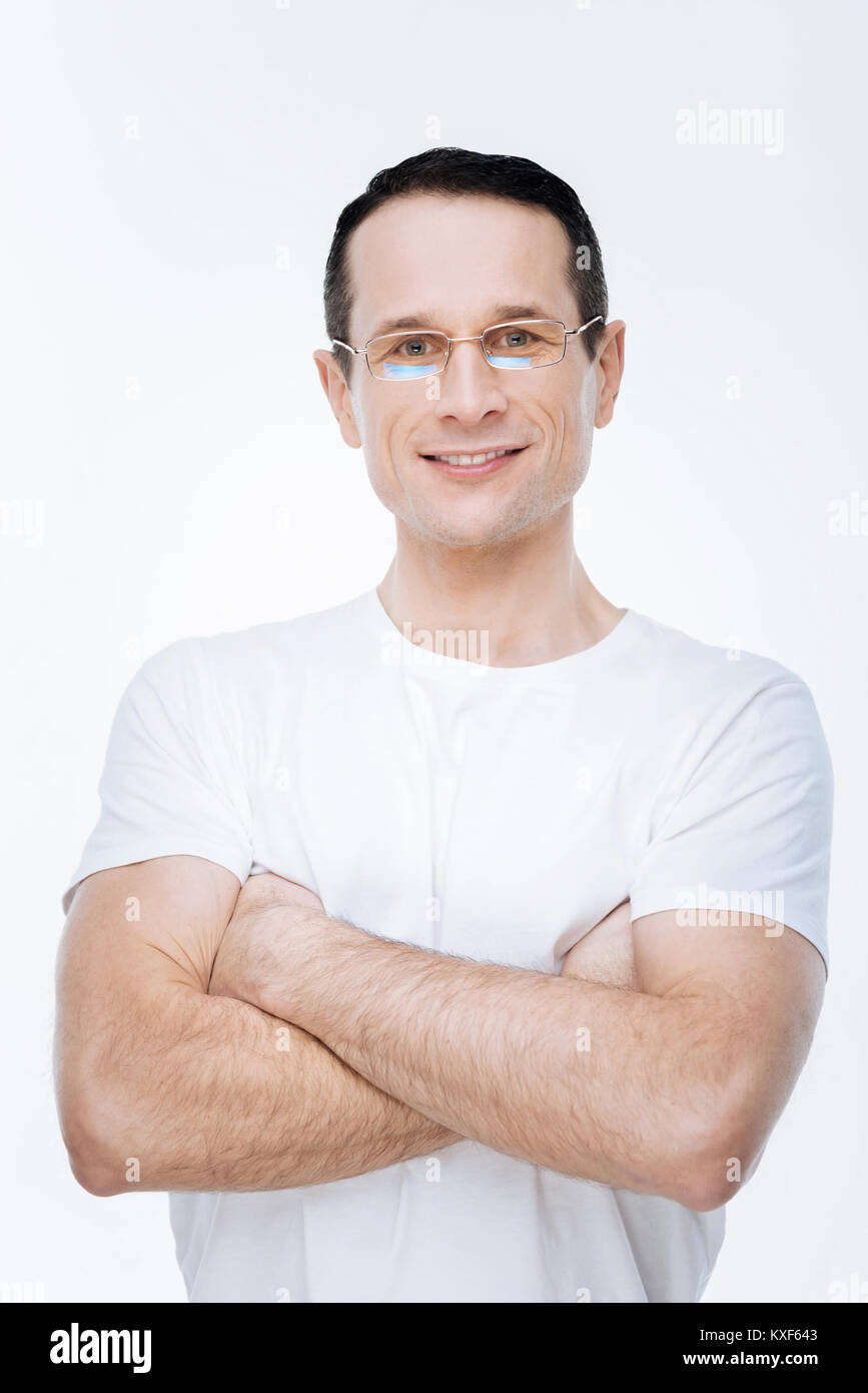Serious smart man standing cross handed Stock Photo - Alamy