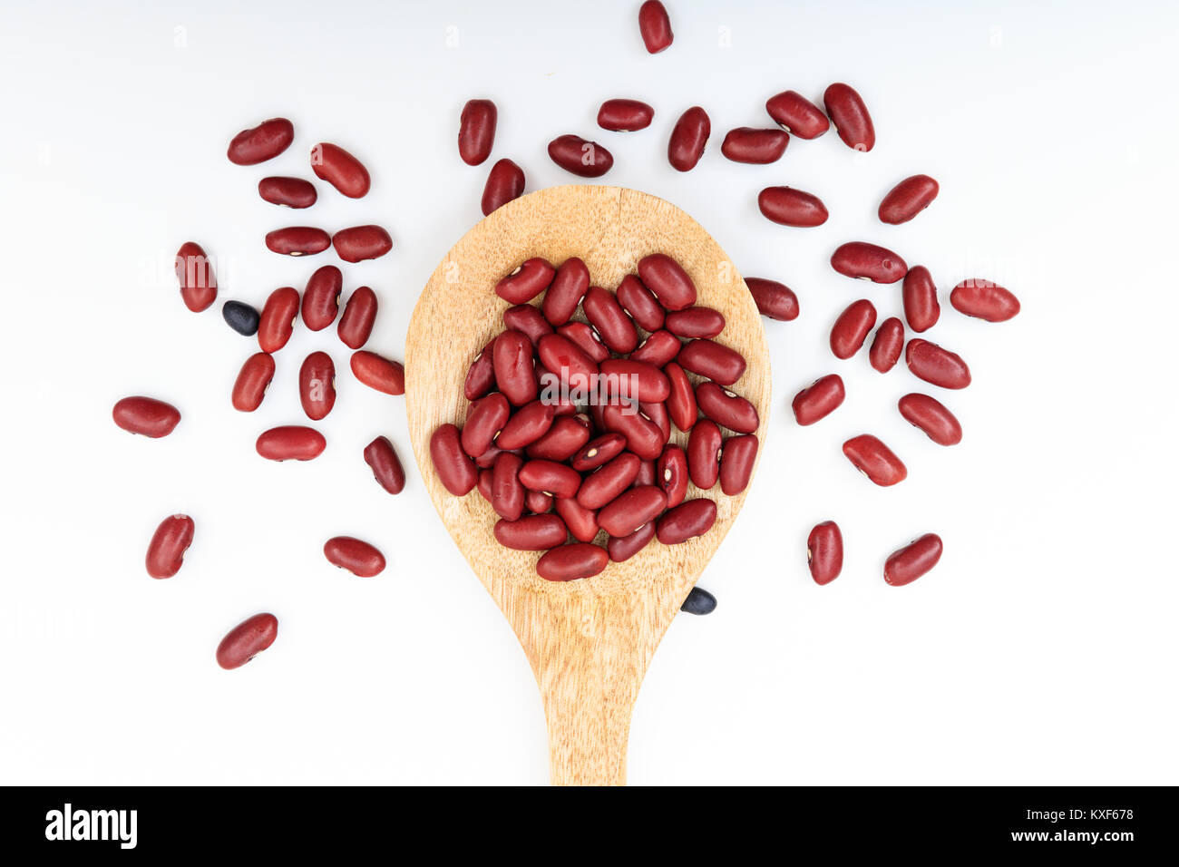 Raw red beans in a wooden spoon on white background Stock Photo - Alamy