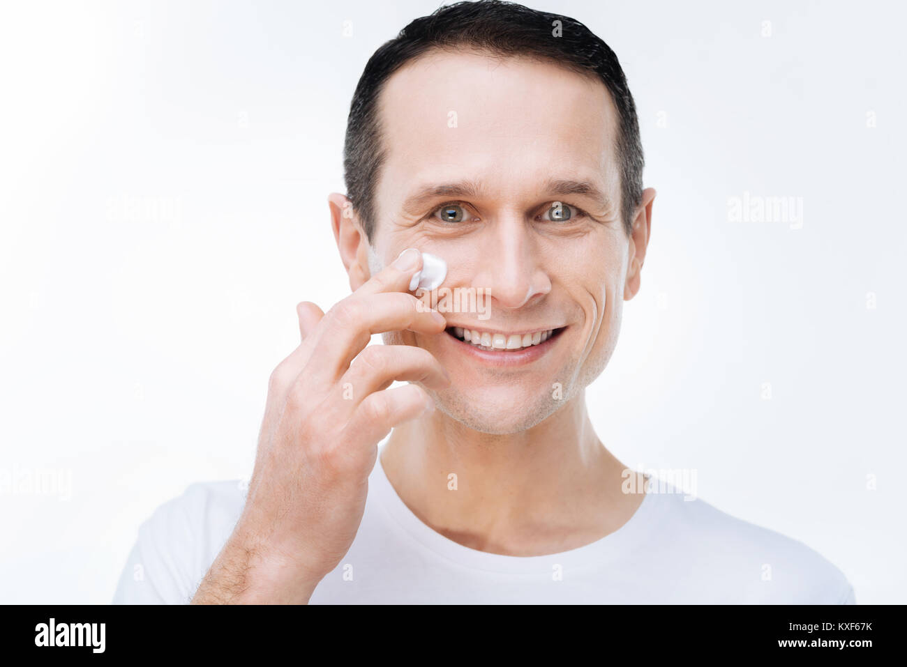 Happy joyful man caring about his skin Stock Photo - Alamy
