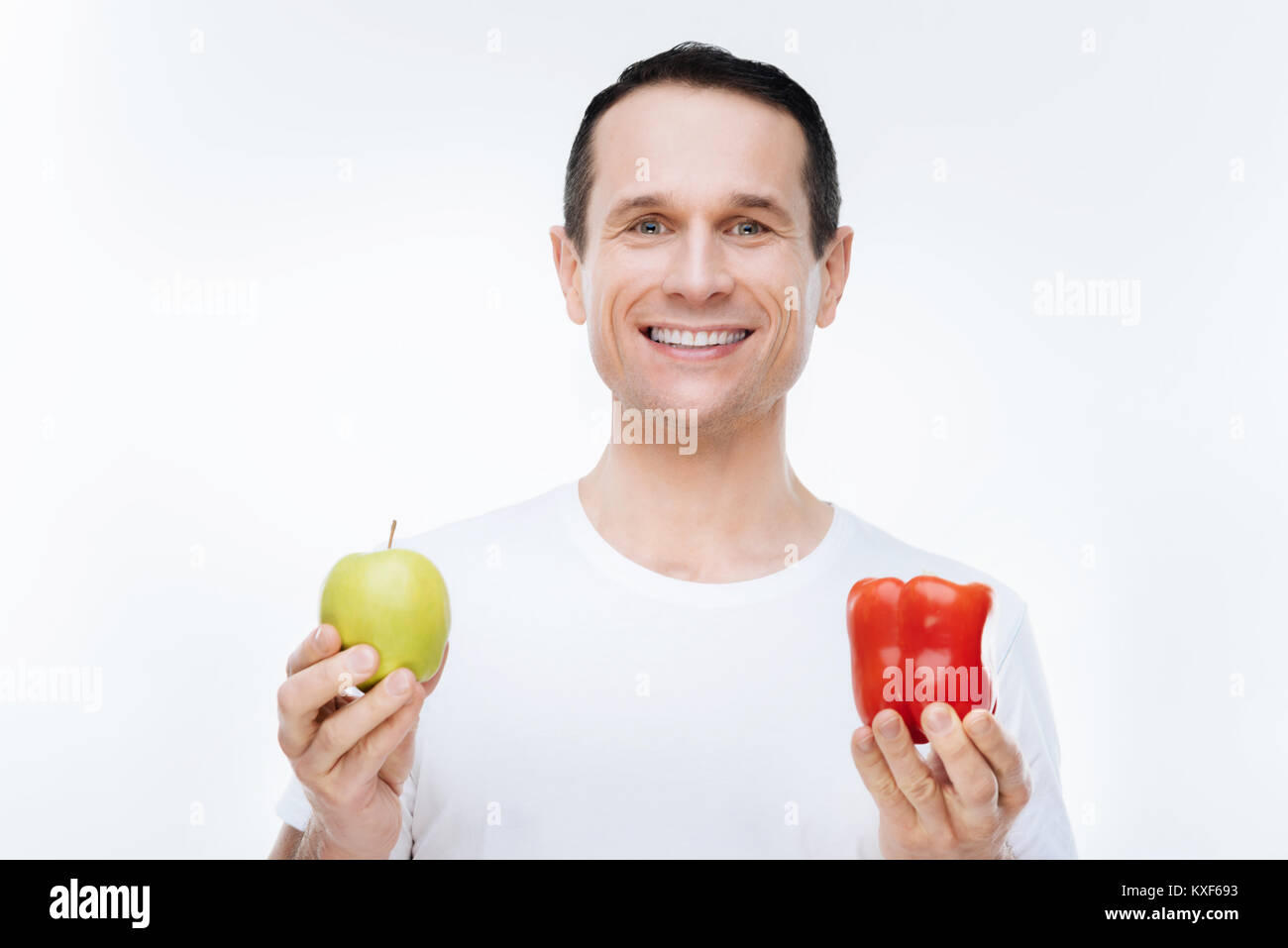 Happy nice man holding healthy food Stock Photo - Alamy
