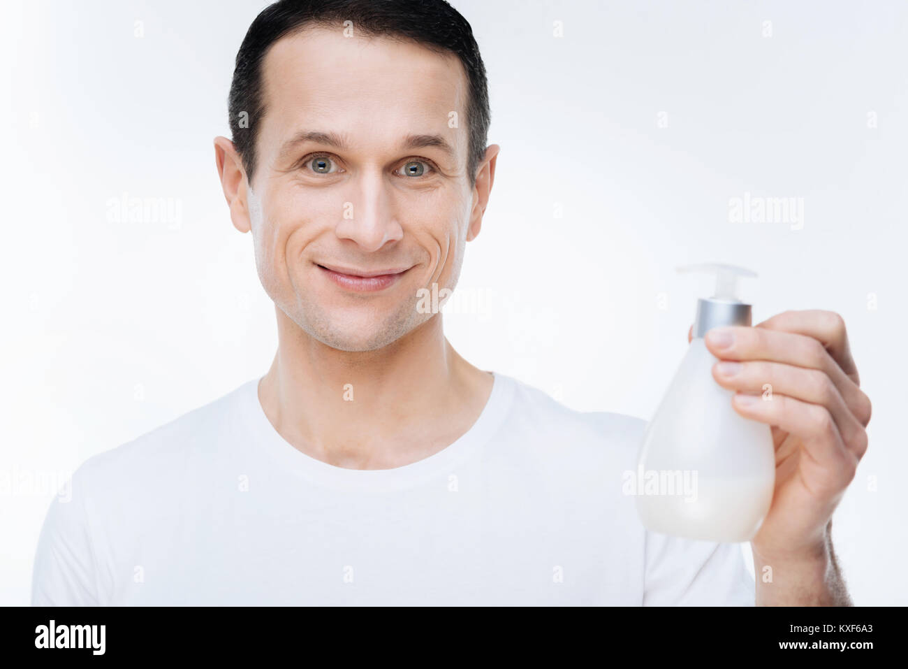 Portrait of a delighted man holding soap Stock Photo - Alamy