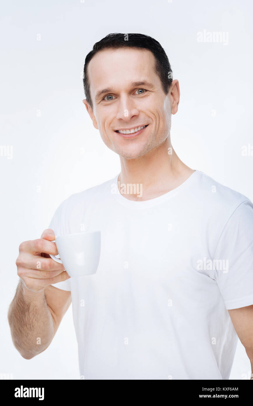 Nice positive man enjoying his coffee Stock Photo - Alamy