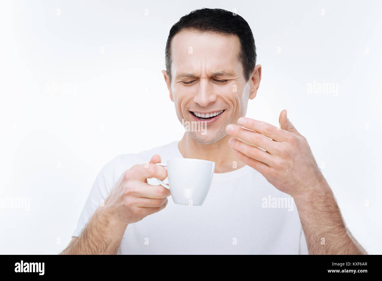 Nice pleasant man smelling the aroma of coffee Stock Photo - Alamy