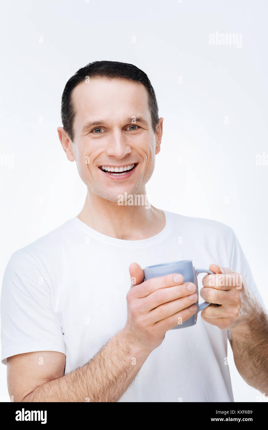 Happy nice man enjoying his tea Stock Photo - Alamy