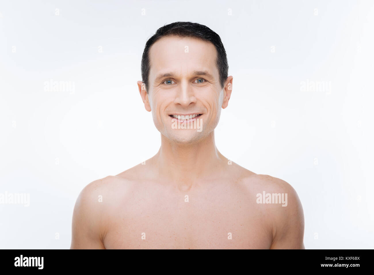 Cheerful pleasant man smiling to you Stock Photo - Alamy