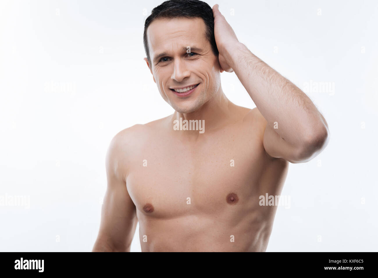 Joyful handsome man touching his hair Stock Photo - Alamy