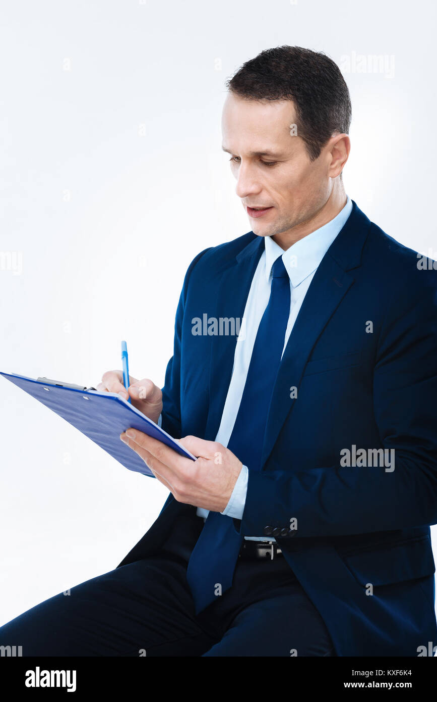 Serious hard working businessman taking notes Stock Photo - Alamy