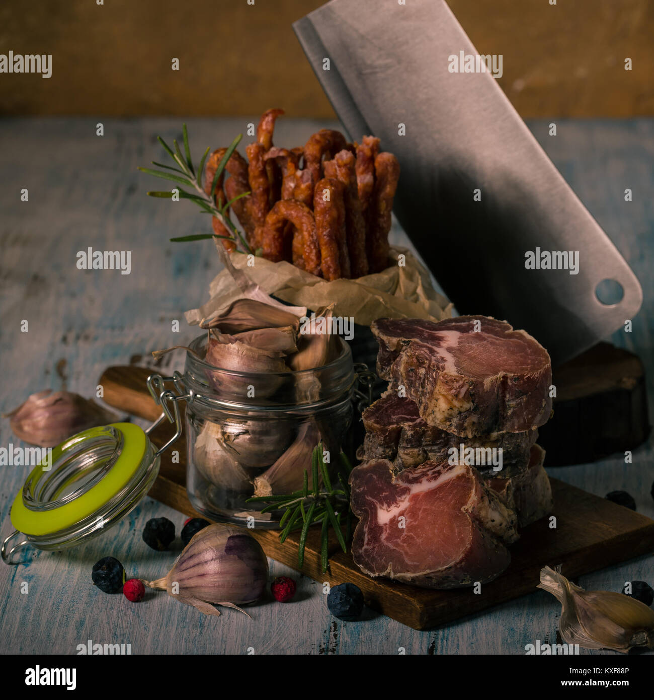 Square photo with stacked dried italian meat from wild boar pig placed ...