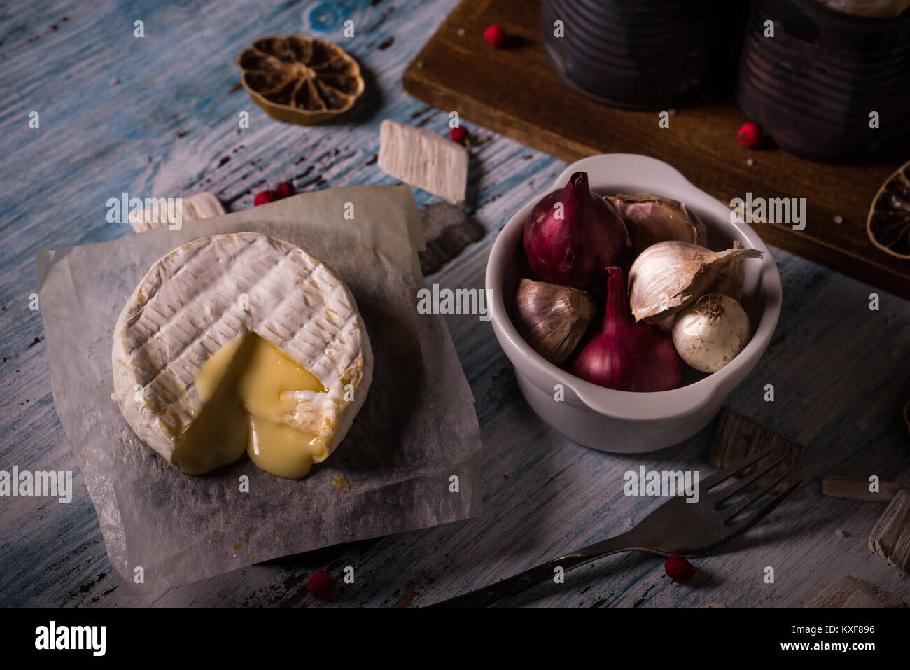 Horizontal photo of hot melted camembert cheese on paper sheet with ...