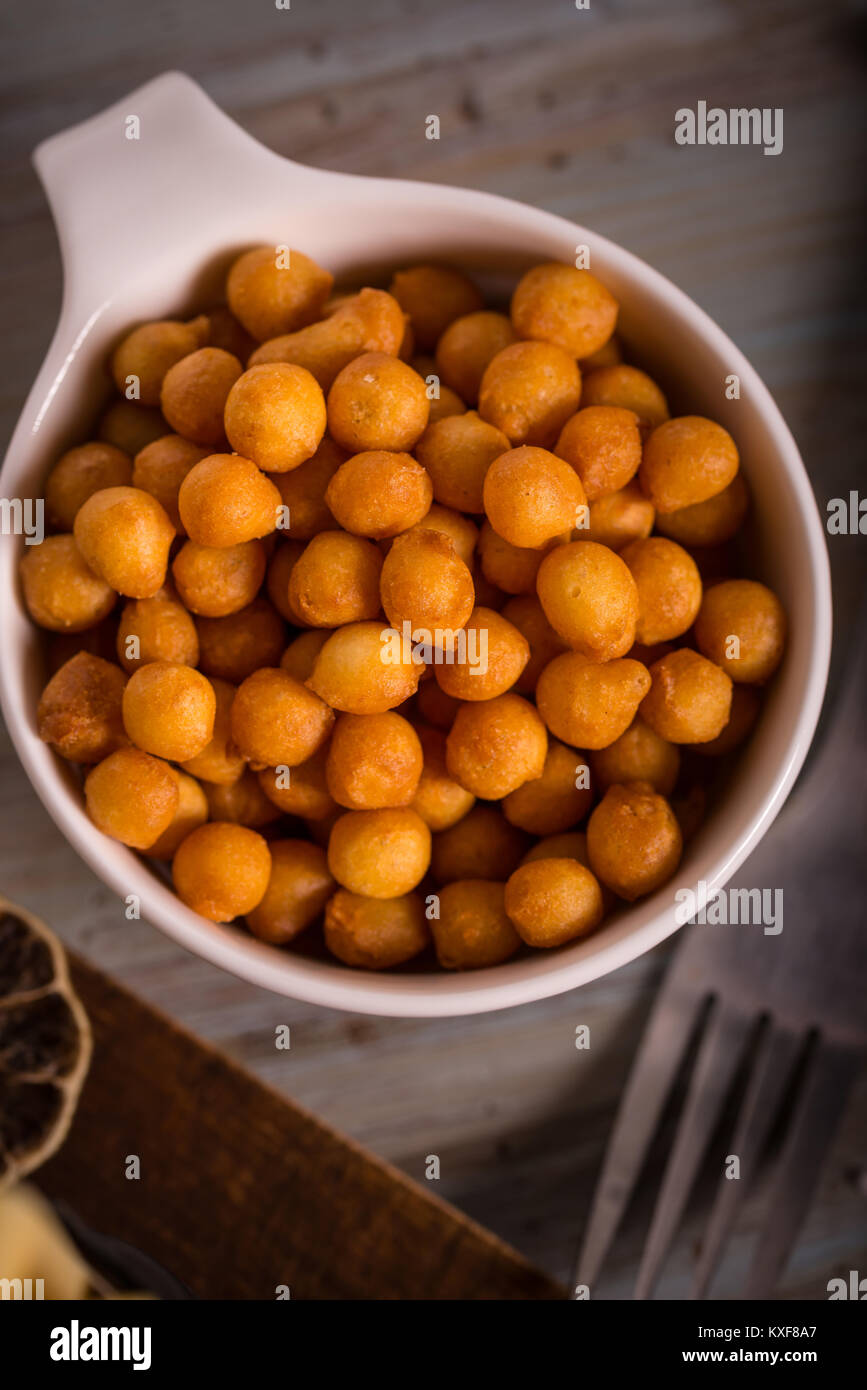 Vertical photo with top view on white cup or bowl full of fried pea ...