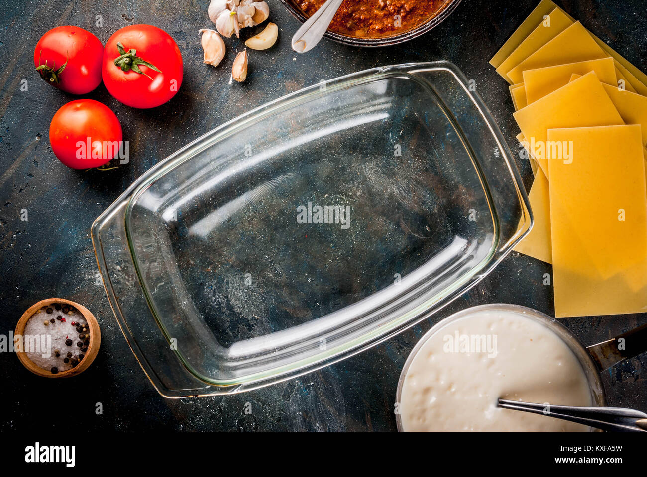 Cooking homemade classic lasagna bolognese, on dark blue table; with ...