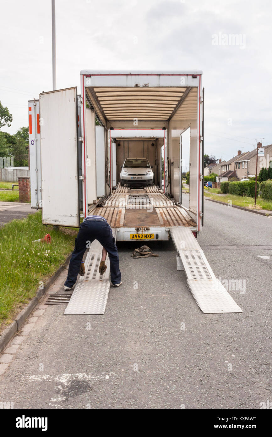 Worker for Ontime Automotive removes recovered breakdown vehicle from ...