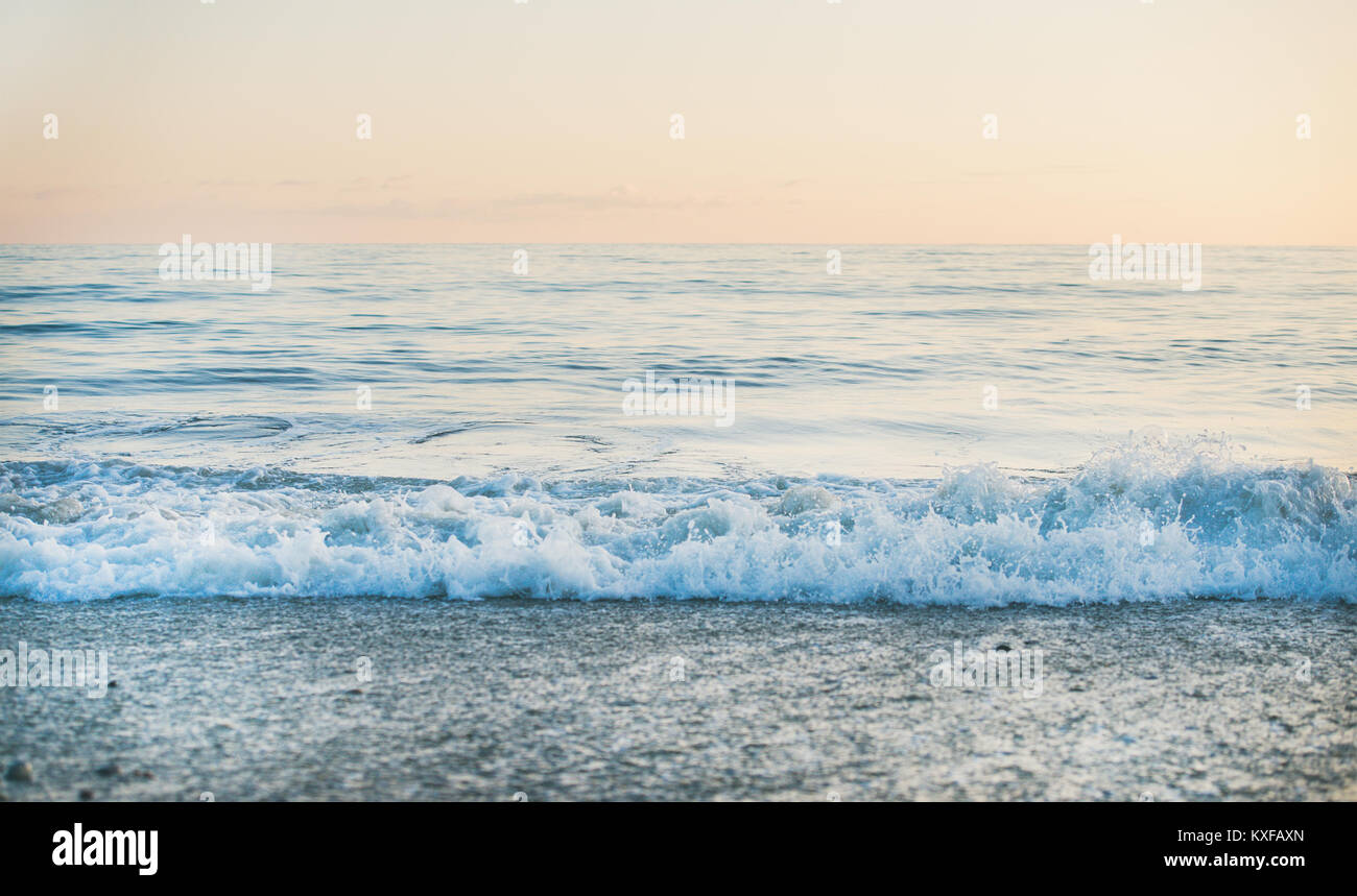 Calm Sea and beach view at sunset, pastel colors Stock Photo - Alamy