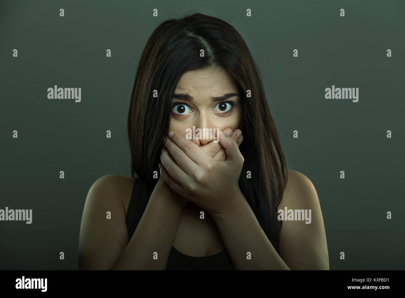 Scared woman with fear expression and hands covering mouth Stock Photo ...