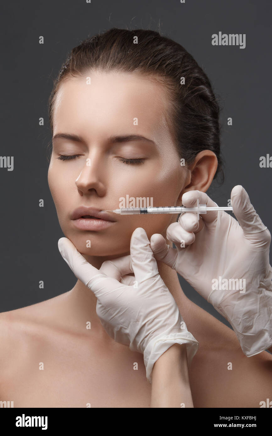 Portrait of young woman getting cosmetic injection. Clean Beauty ...