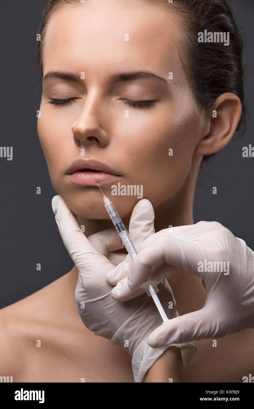 Portrait of young woman getting cosmetic injection. Clean Beauty Stock ...