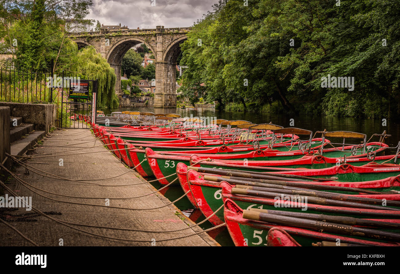 The riverside at Knaresborough North Yorkshire. Many red rowing boats ...