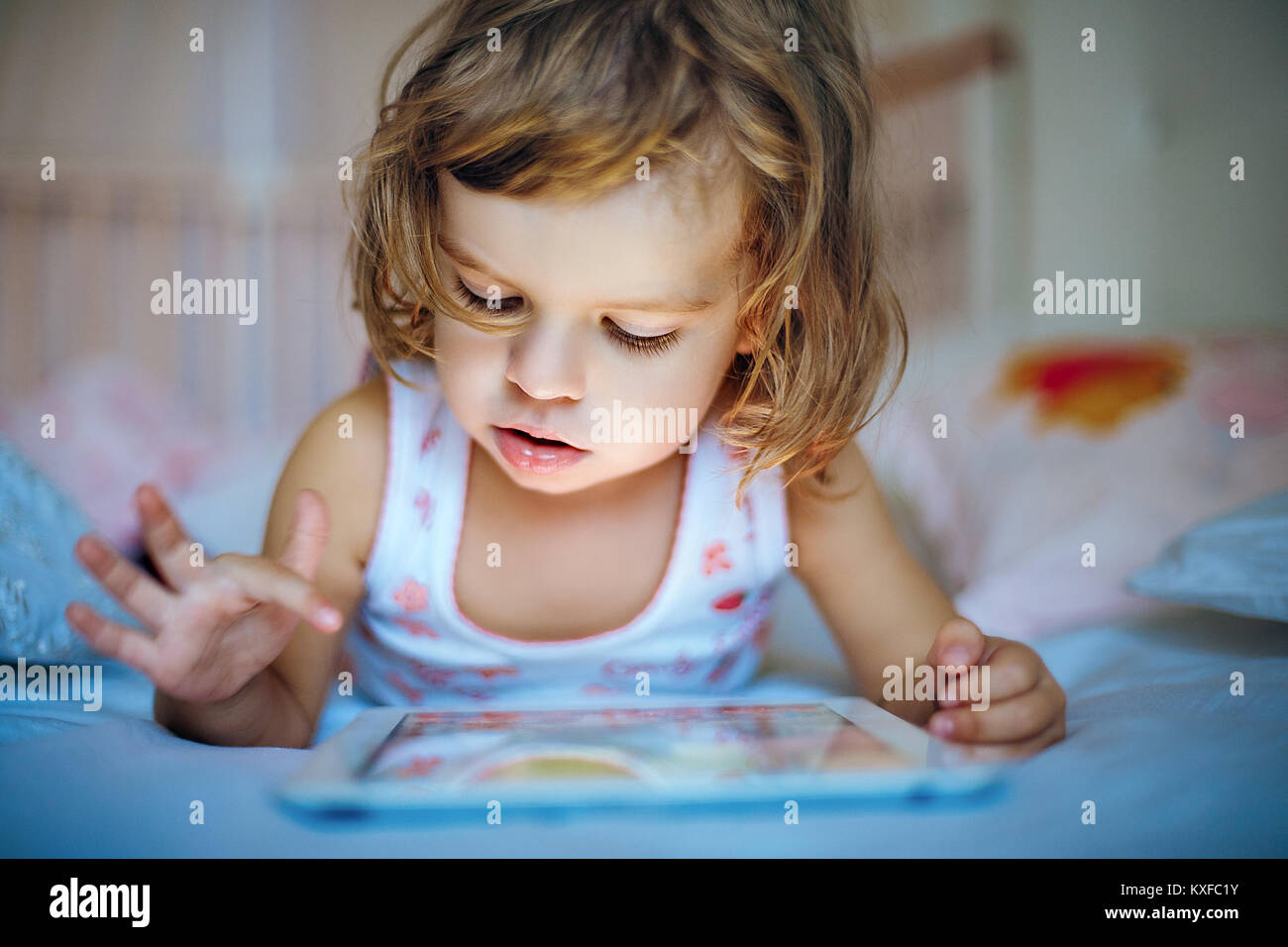 little girl playing tablet Stock Photo - Alamy