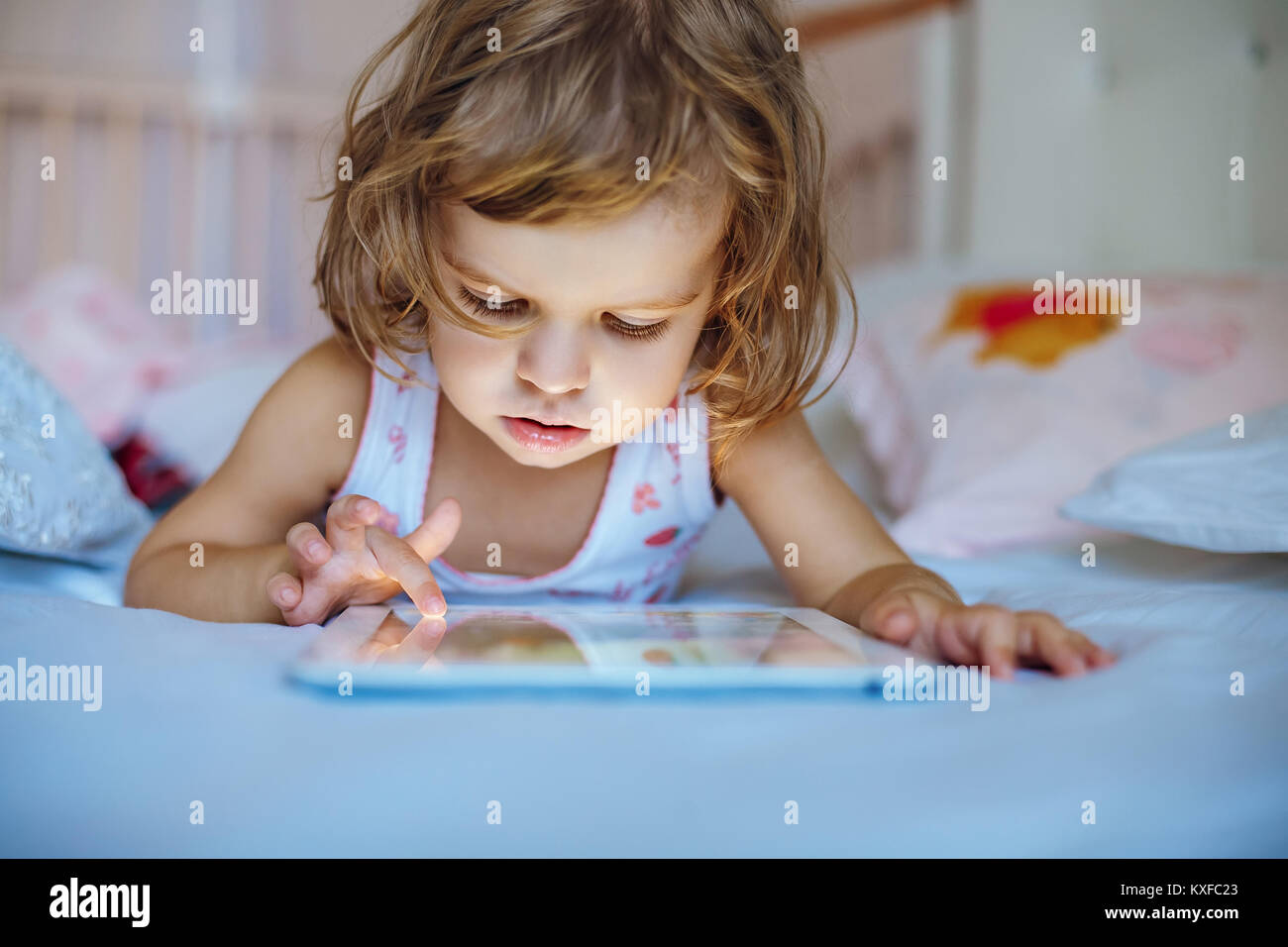 little girl playing tablet Stock Photo - Alamy