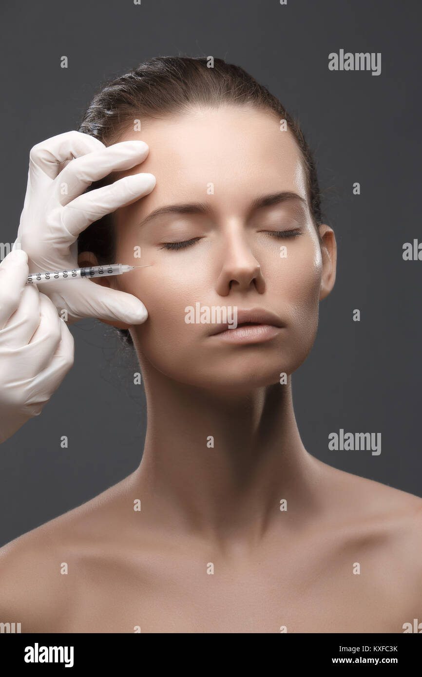 Portrait of young Caucasian woman getting cosmetic injection Stock ...