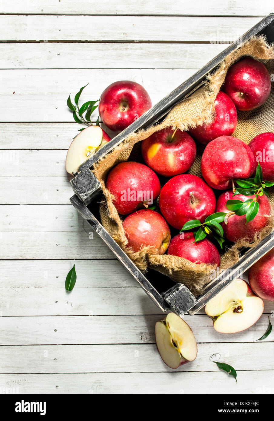 Red apples in a box. On a white wooden background Stock Photo - Alamy