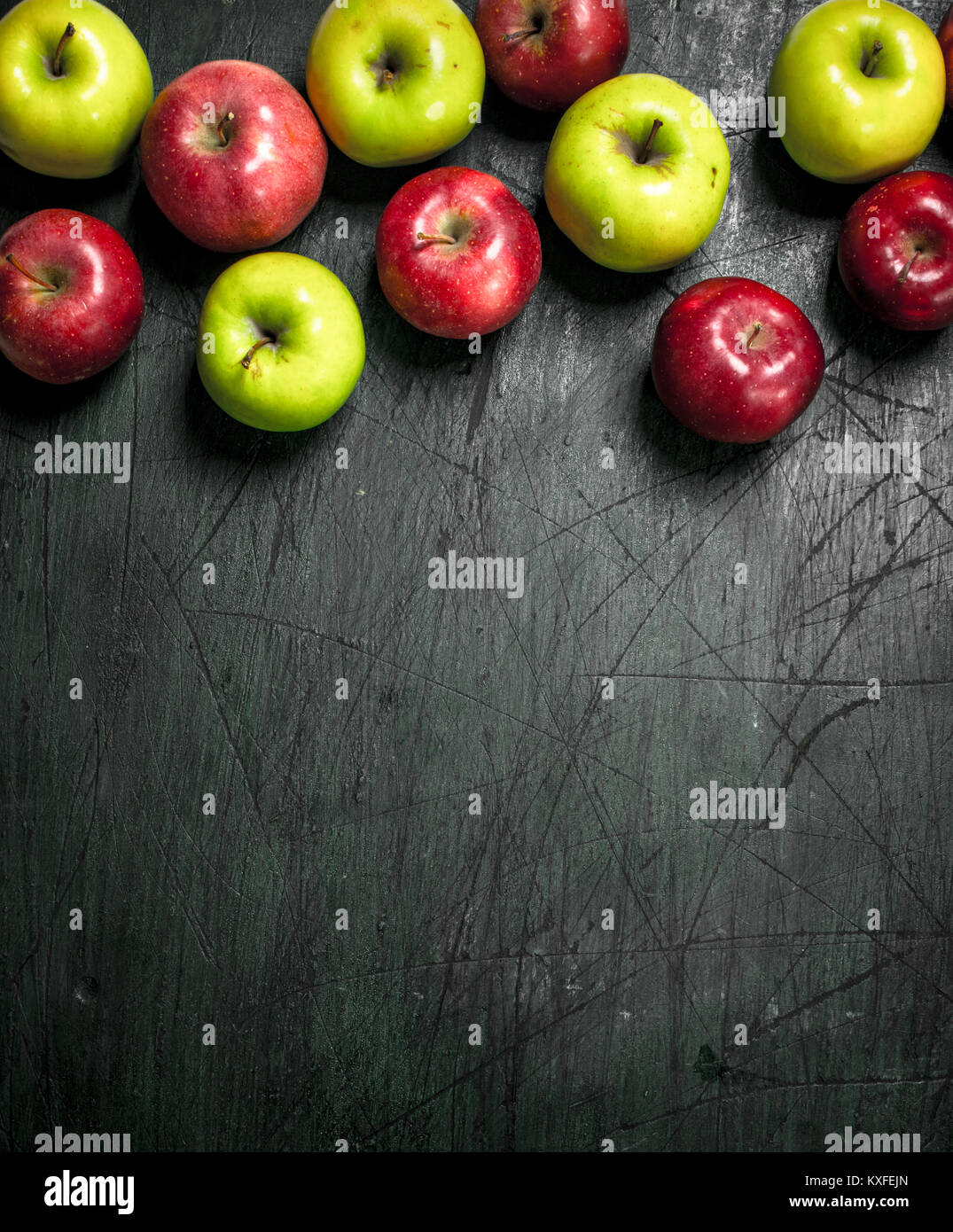 Red and green apples. On a rustic background Stock Photo - Alamy