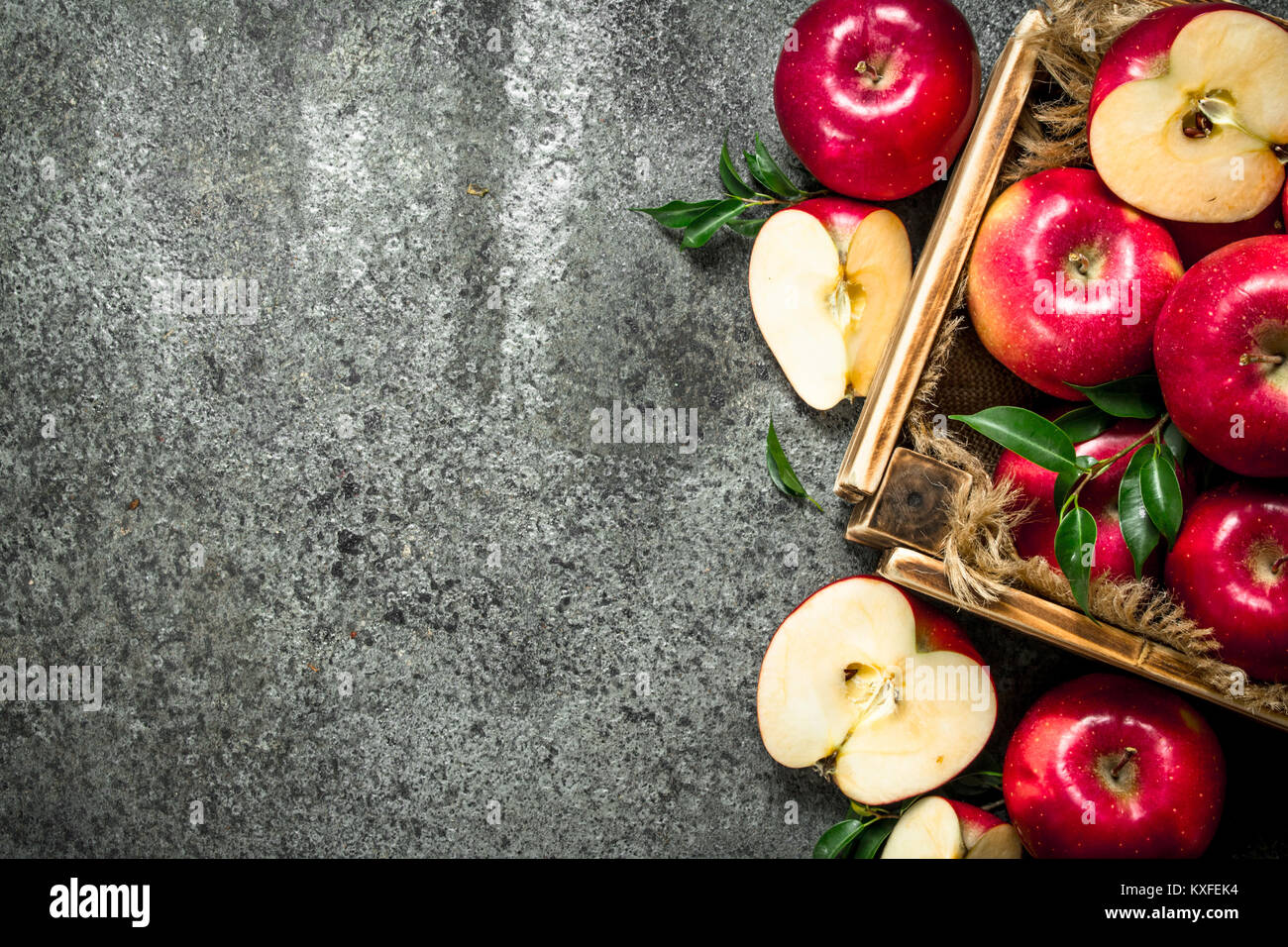 box with ripe red apples. On a rustic background Stock Photo - Alamy