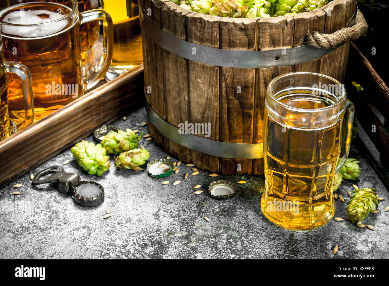 Beer background. Fresh beer with ingredients. On a rustic background ...