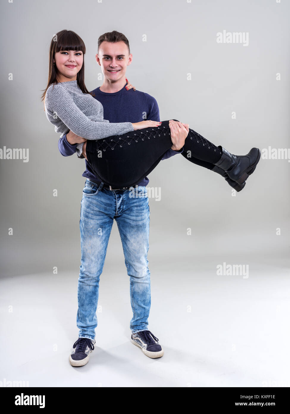 Teenage couple with the boy carrying his girlfriend Stock Photo - Alamy