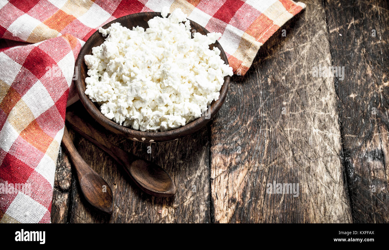 Cottage cheese from fresh cow milk. On a wooden background Stock Photo ...
