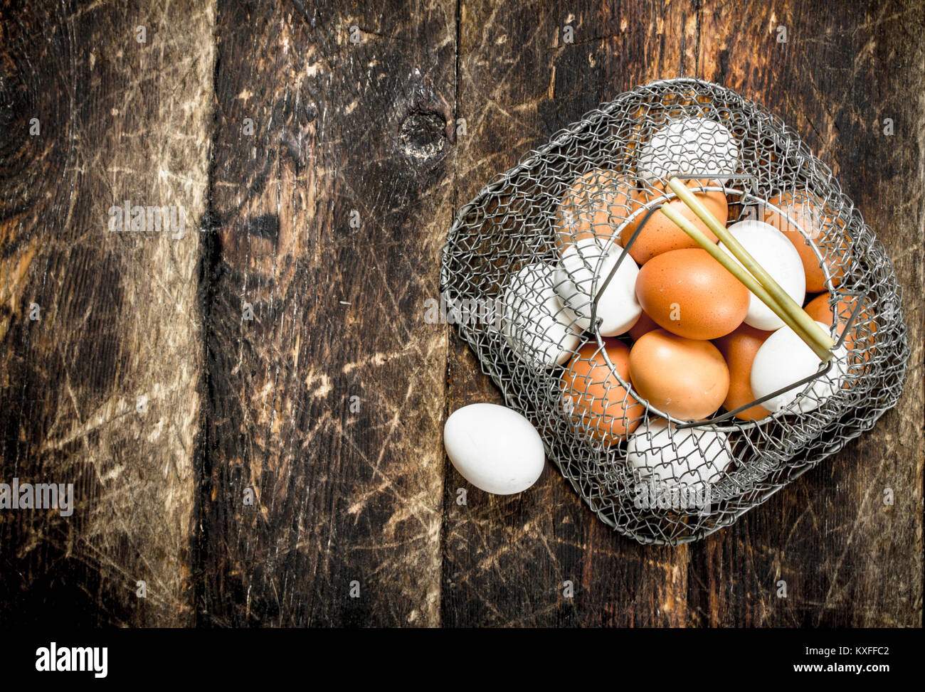Fresh eggs in a mesh bag. On a wooden background Stock Photo - Alamy