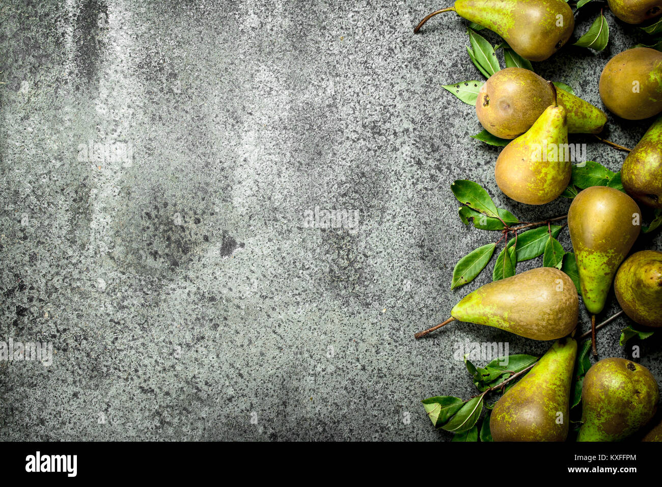 Ripe pears with leaves. On a rustic background Stock Photo - Alamy