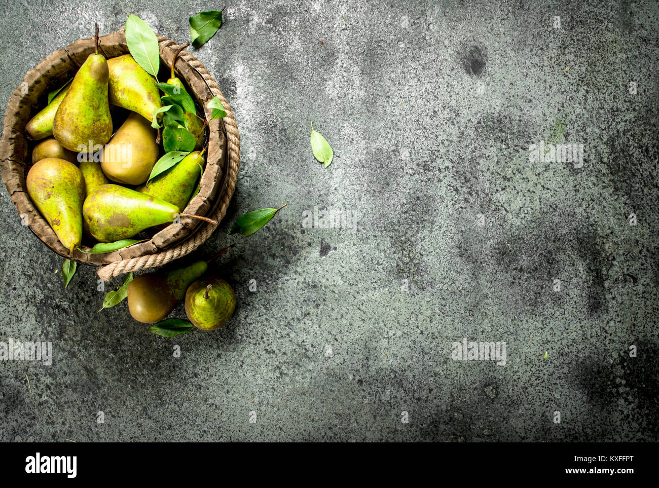 Ripe pears in a wooden bucket. On a rustic background Stock Photo - Alamy