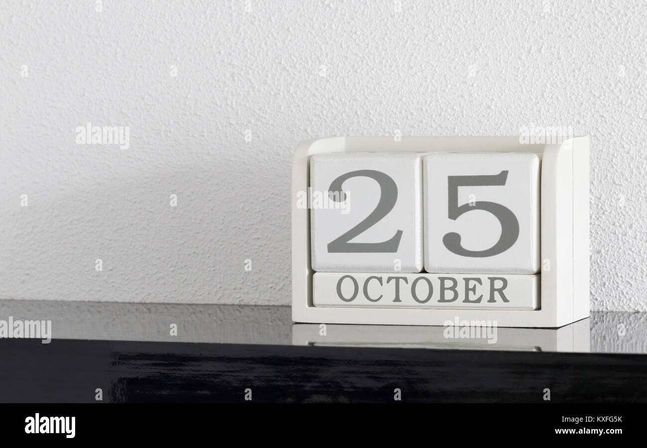 White block calendar present date 25 and month October on white wall ...