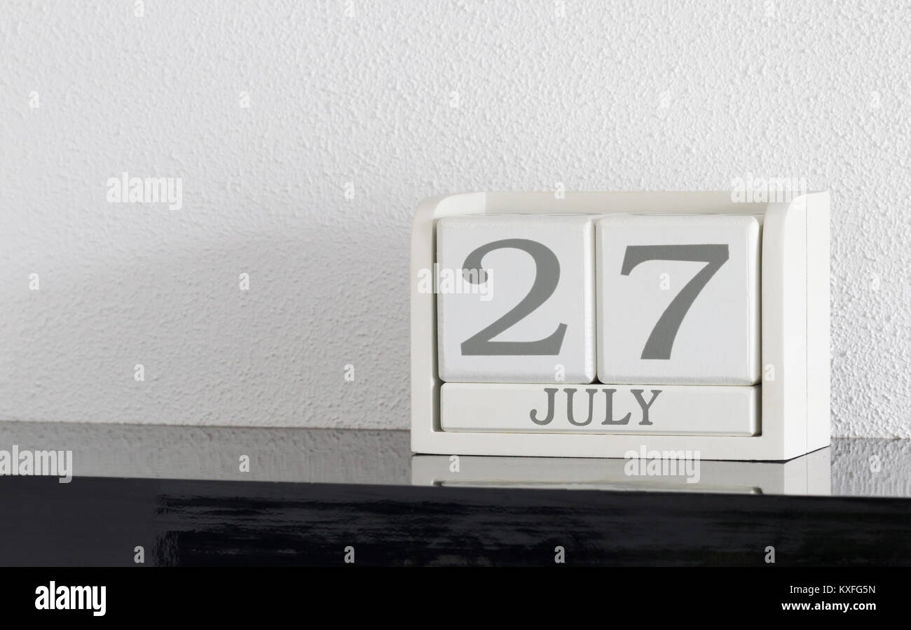 White block calendar present date 27 and month July on white wall ...