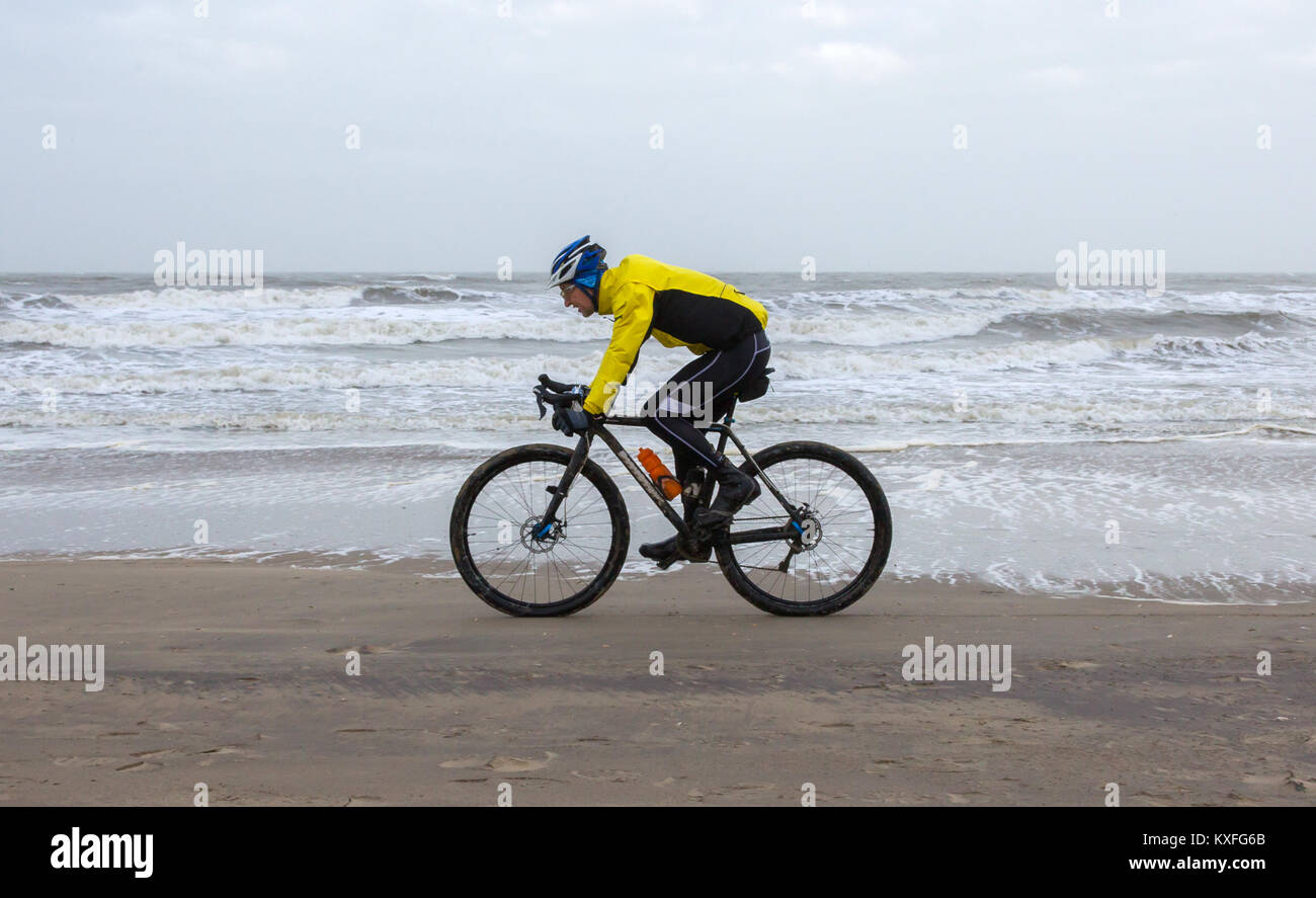 Scheveningen, The Netherlands - 30 December 2017: Cyclist on the beach ...