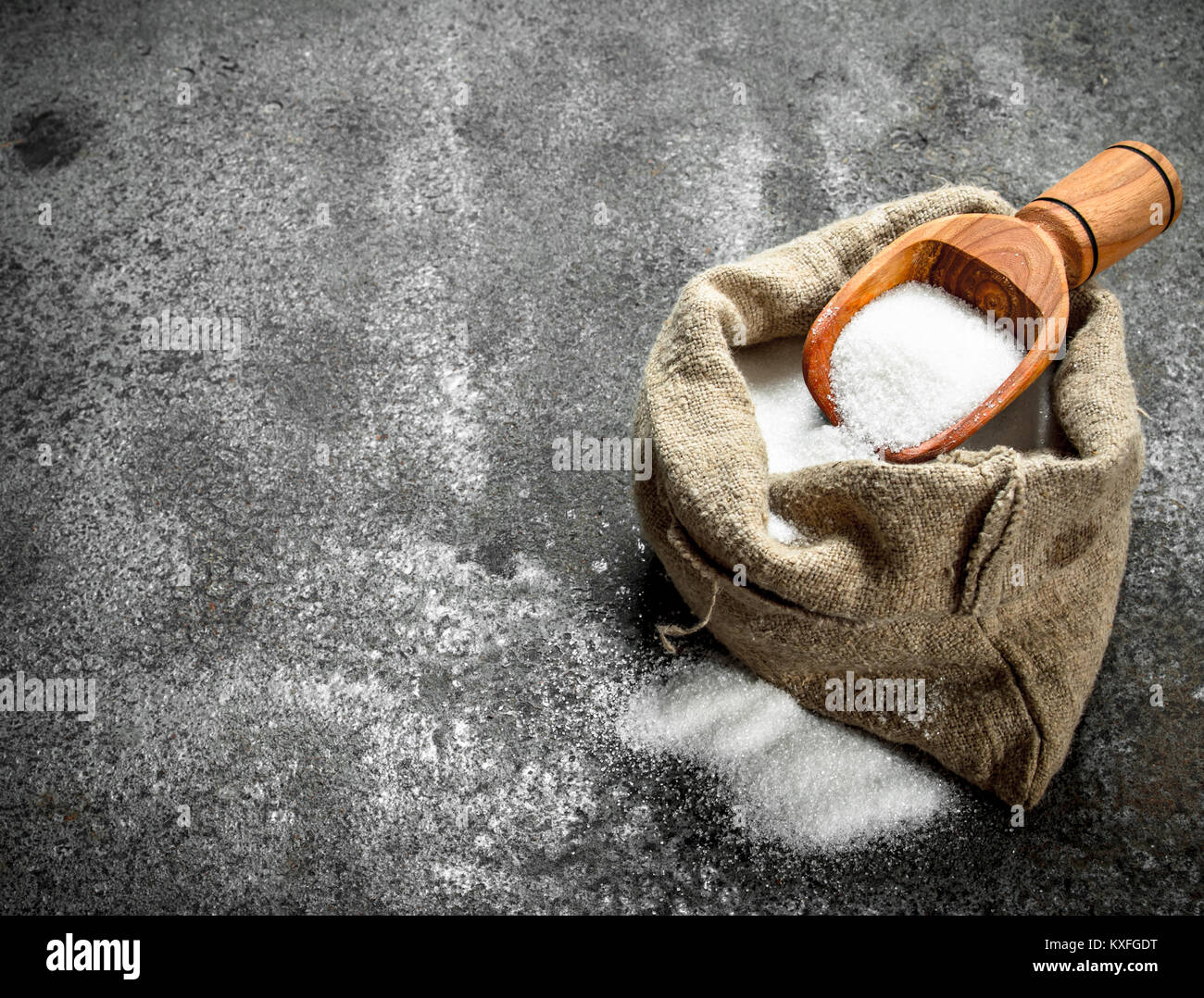 Sugar in an old sack with a scoop. On a rustic background Stock Photo ...