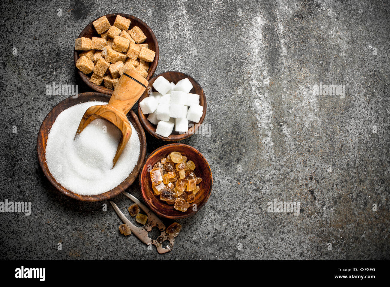 Different kinds of sugar in bowls. On a rustic background Stock Photo ...