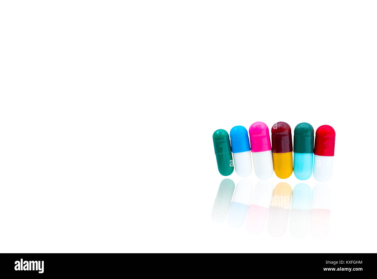 Antibiotic capsules pills in a row on white background with shadows and ...