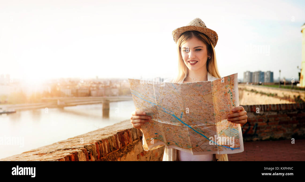 Tourist woman looking at map Stock Photo - Alamy