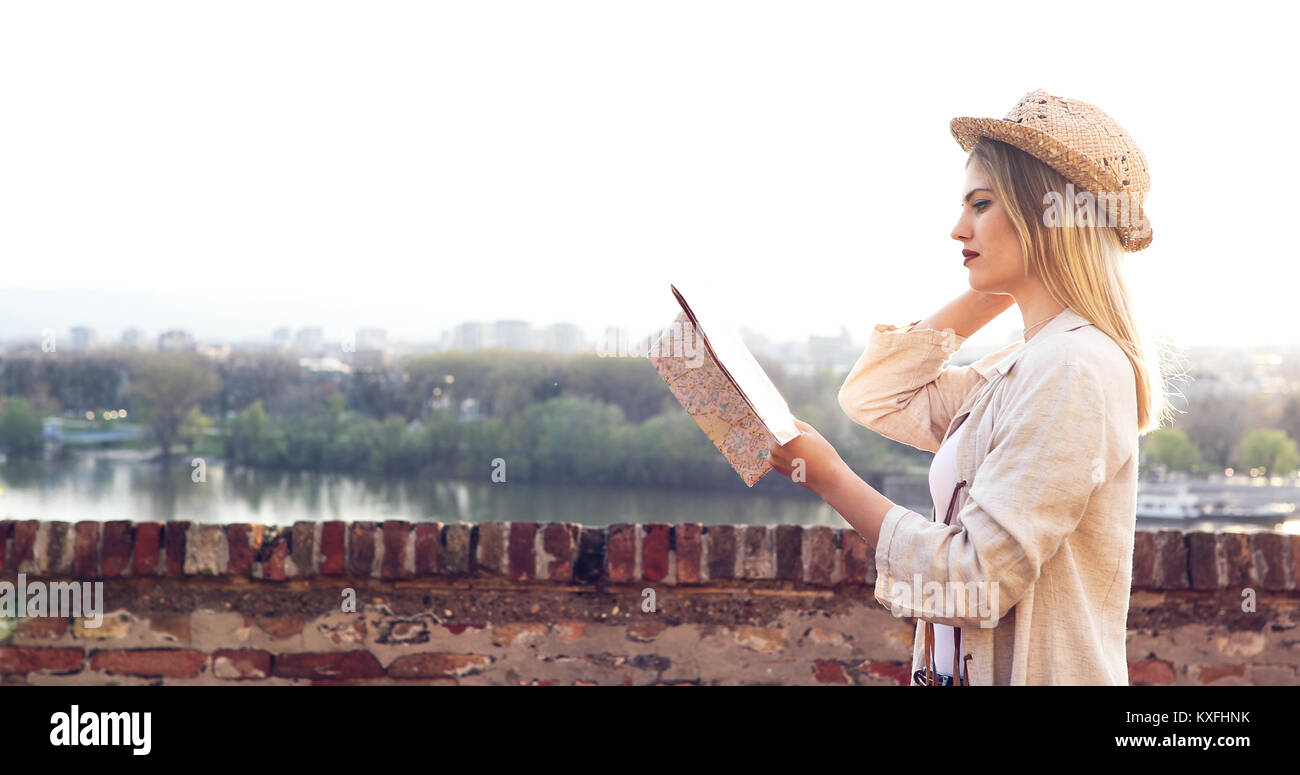 Happy tourist woman on vacation with map visiting city Stock Photo - Alamy