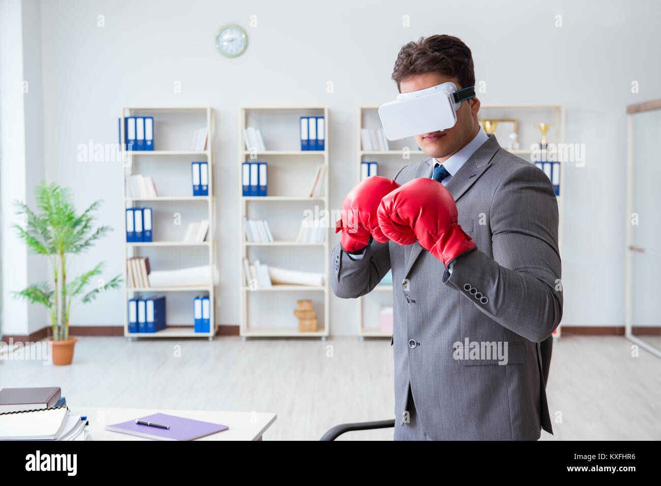 Man boxing in the office with virtual reality goggles Stock Photo - Alamy